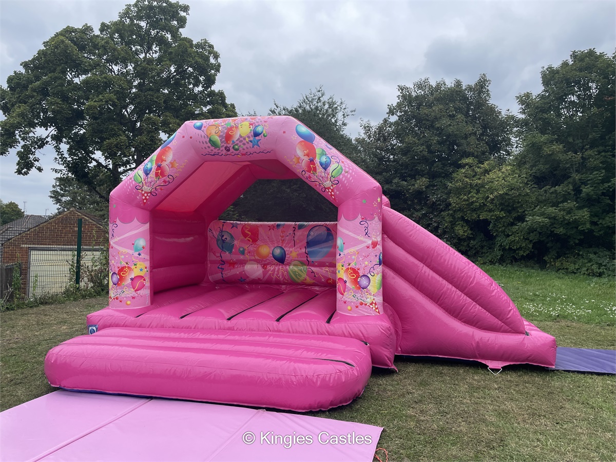 Pink Partytime Slide Bouncy Castle to hire from kingies castles